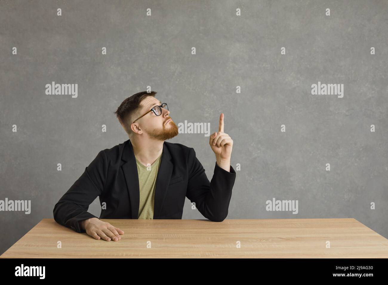 Smart young Caucasian man shows a thumbs up as a sign that he has a ...