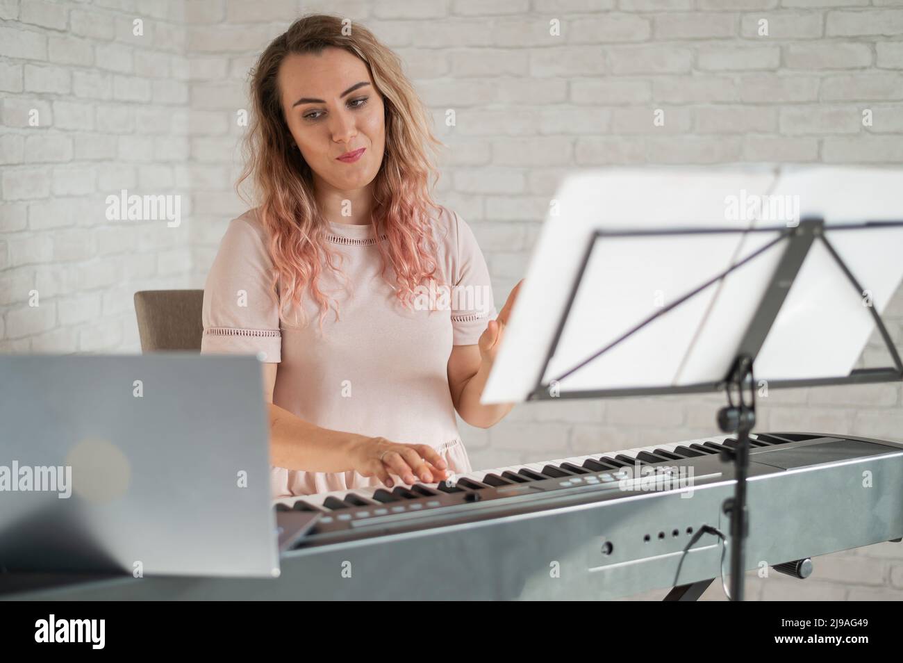 Remote music lessons. A singing teacher records the lesson on a laptop ...