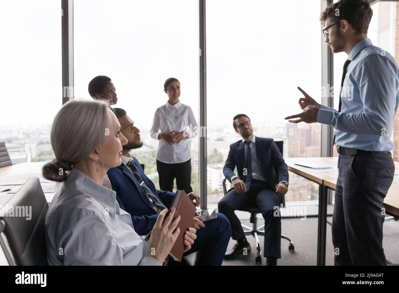 Diverse employees gathered in conference room at briefing Stock Photo ...