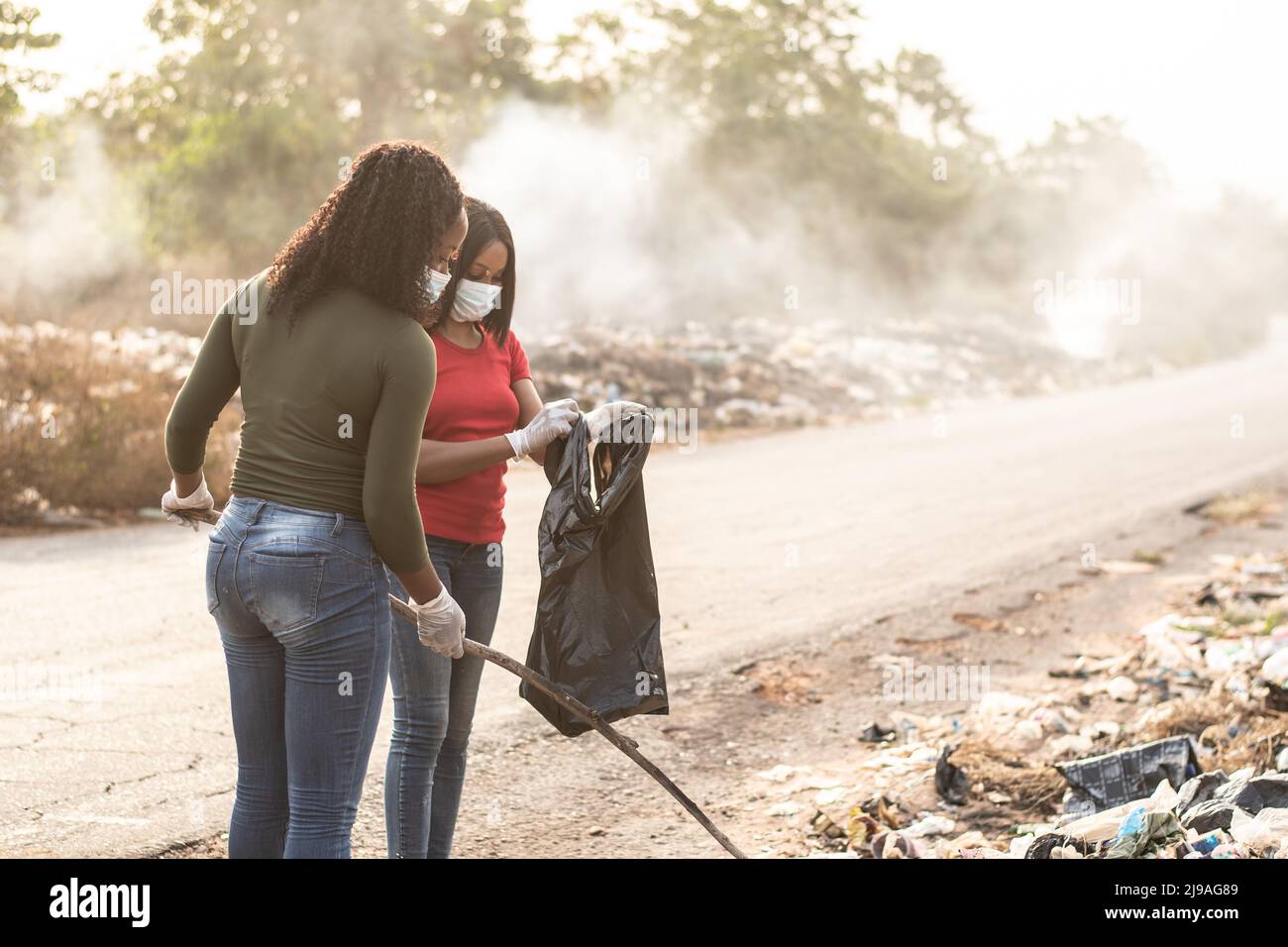 black women cleaning up a dirty place Stock Photo - Alamy