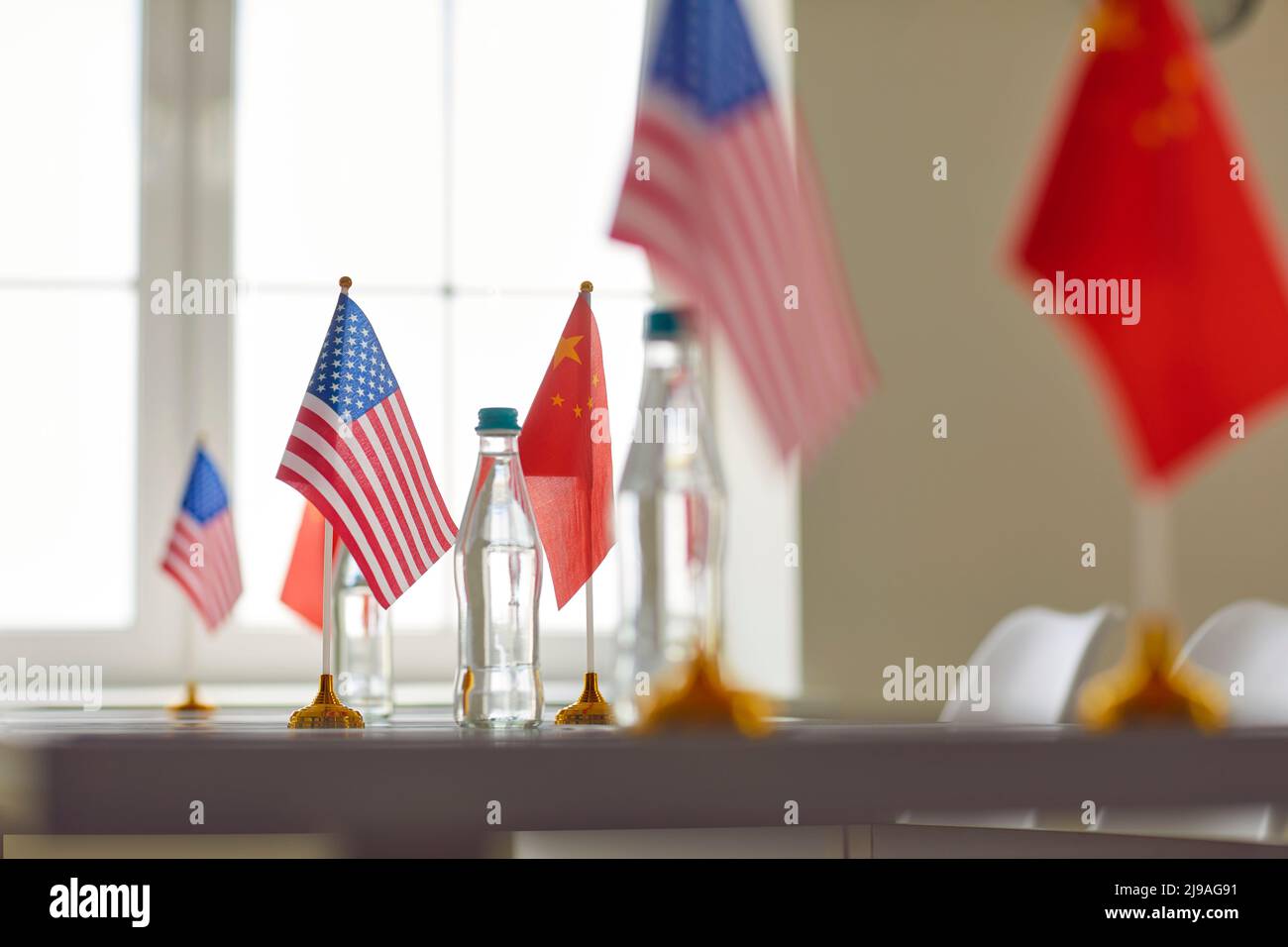 Flags of China and America on conference table symbolizing cooperation ...