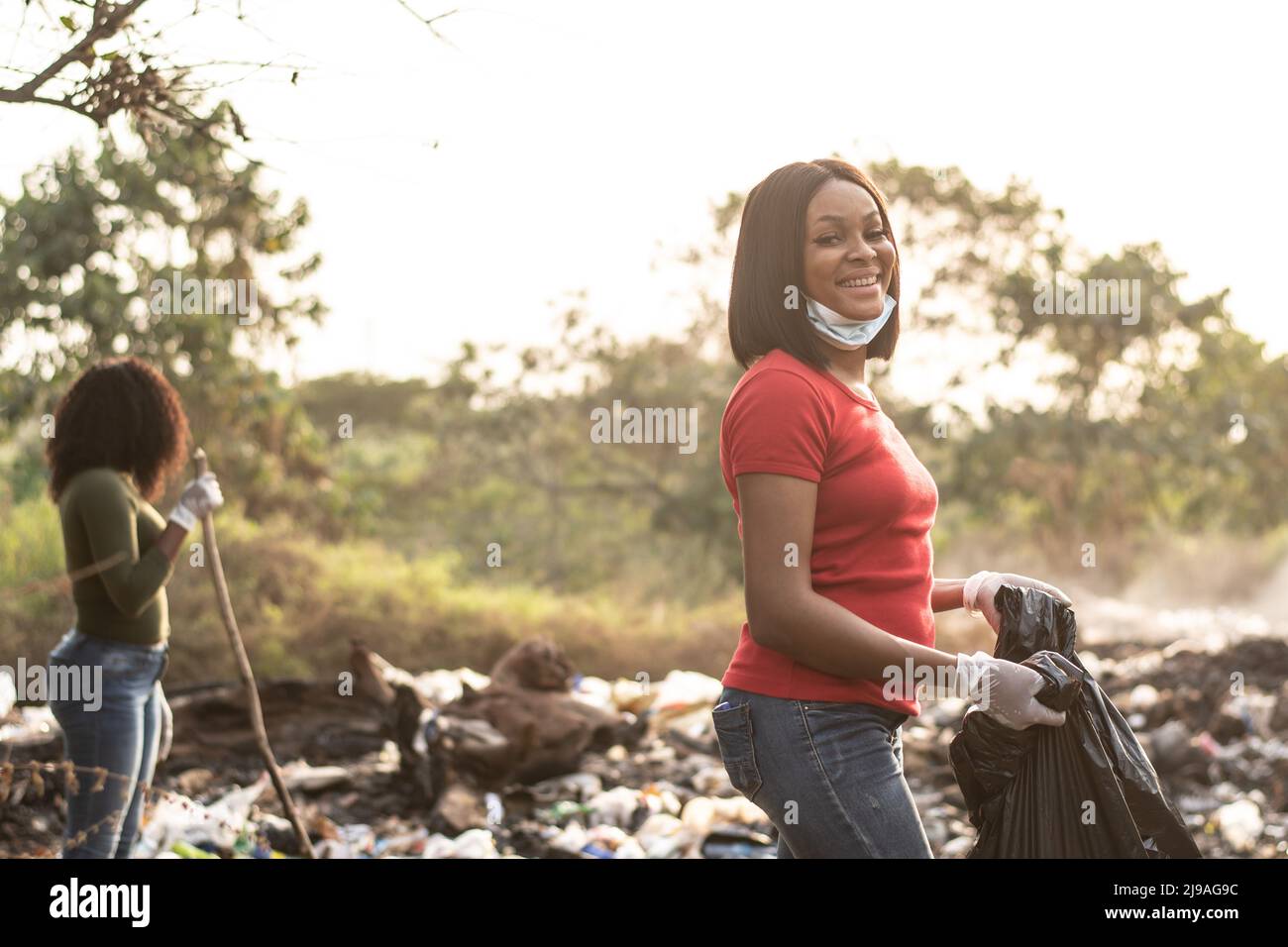 black woman cleaning up a dirty place smiling Stock Photo - Alamy