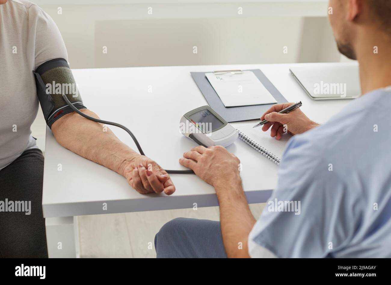 Senior woman with hypertension gets her blood pressure measured during ...