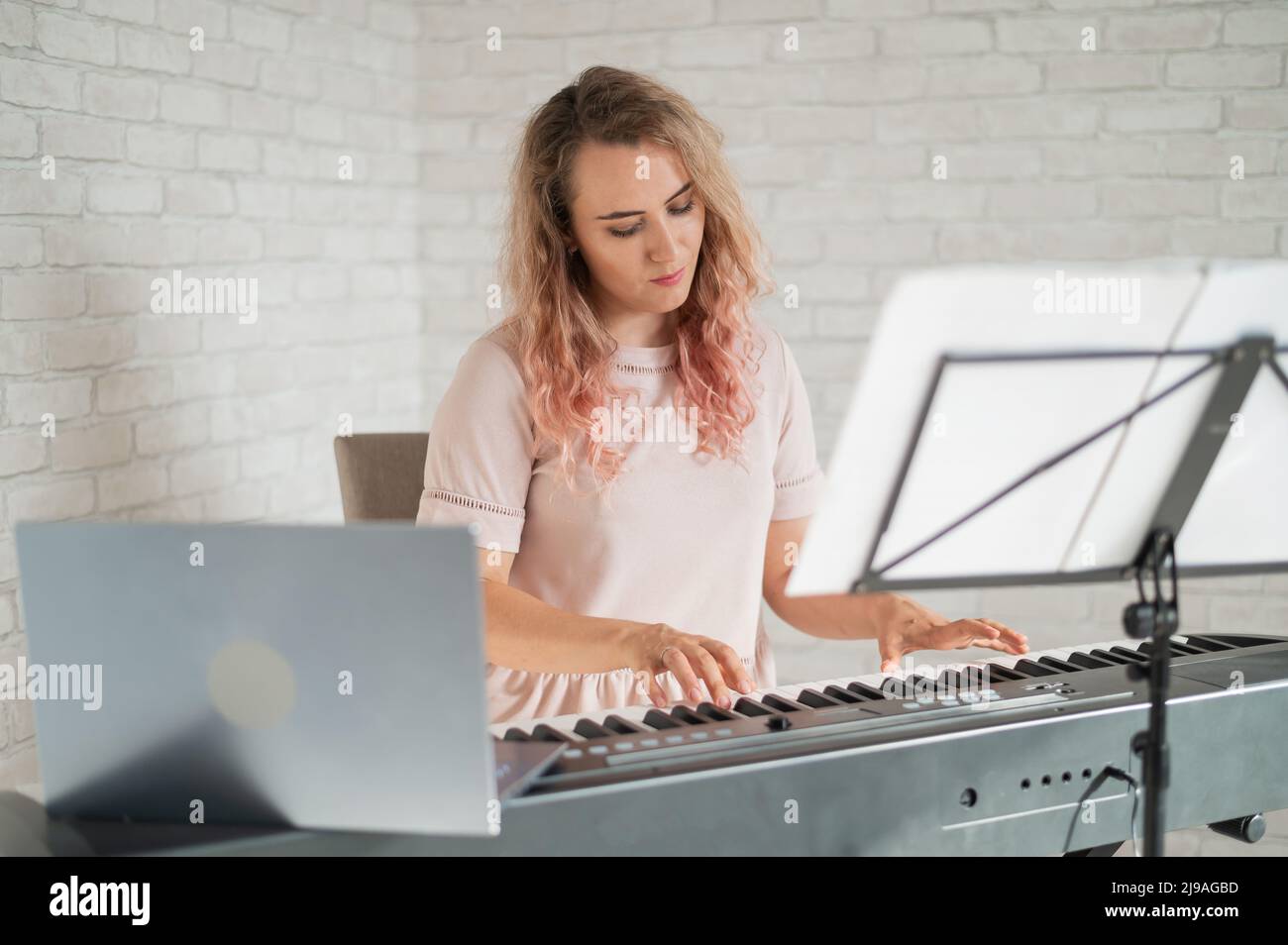 Remote music lessons. A singing teacher records the lesson on a laptop ...