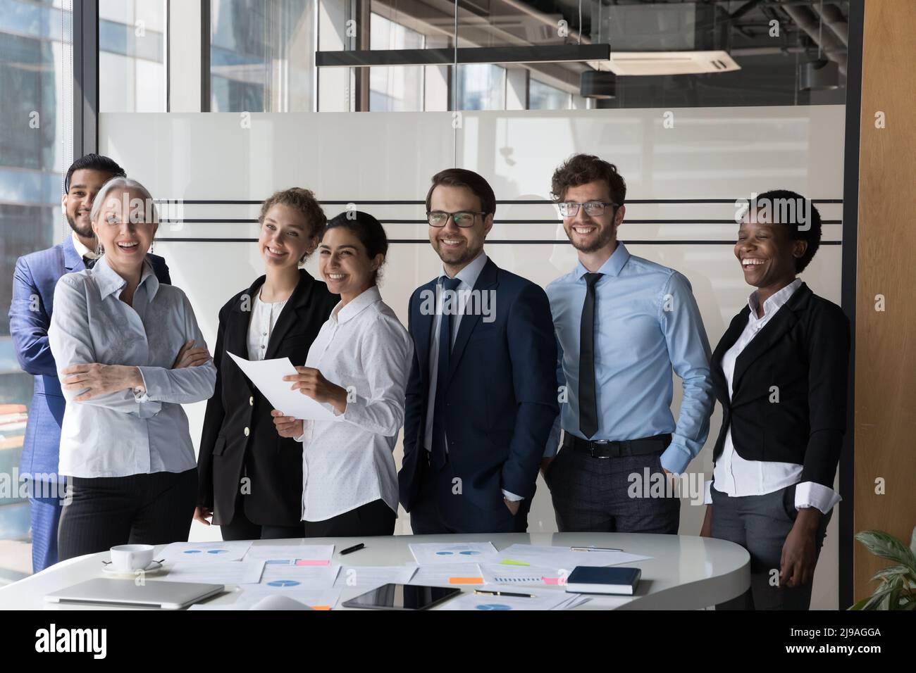 Multiethnic employees smile for camera pose in modern office boardroom ...