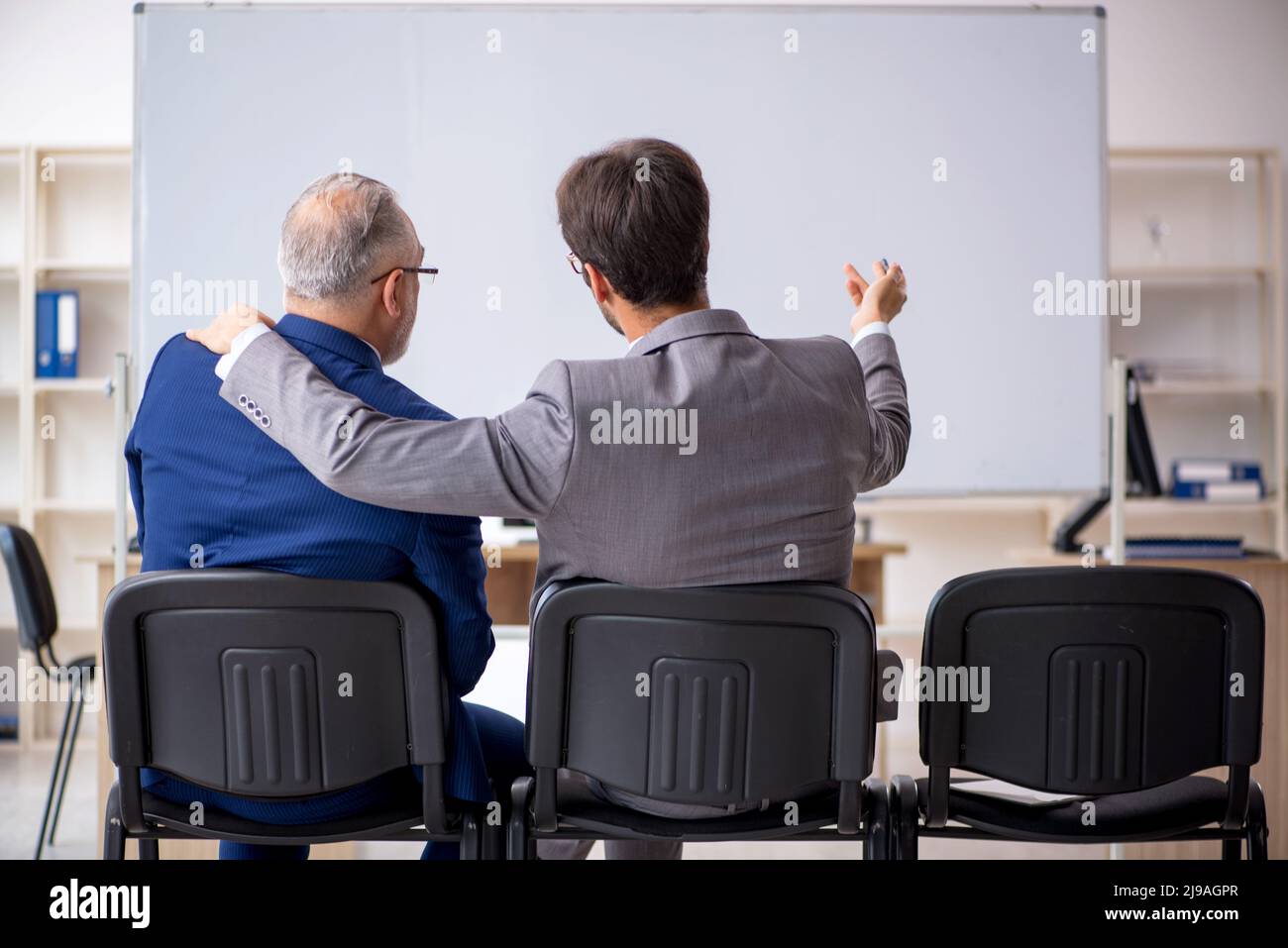 Two colleagues in business presentation concept Stock Photo - Alamy