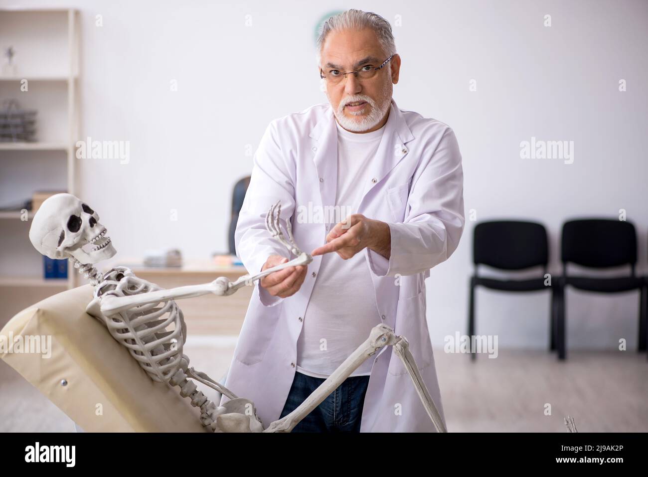 Old doctor with skeleton at the hospital Stock Photo - Alamy