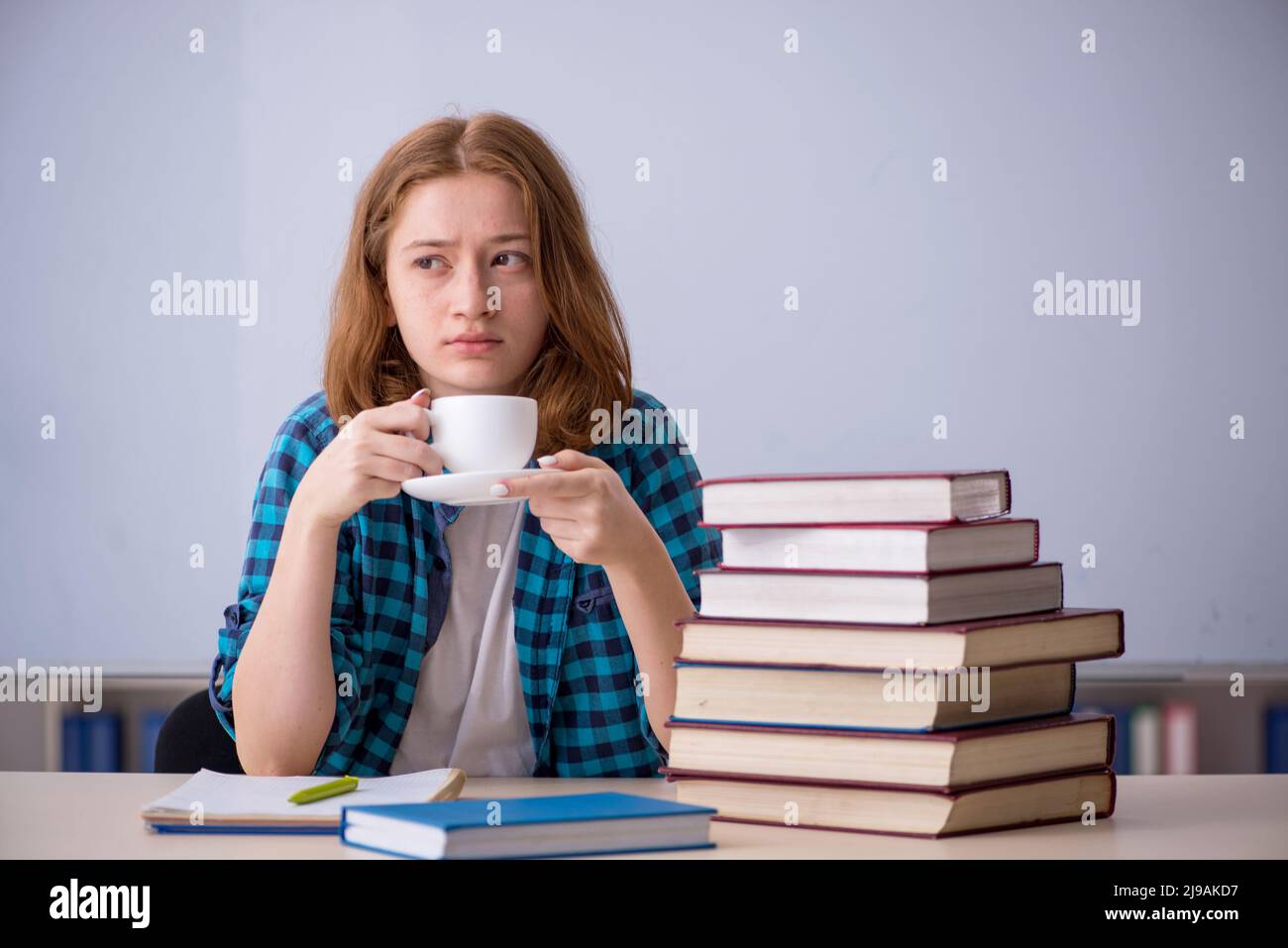 Young girl student drinking coffee during break Stock Photo - Alamy