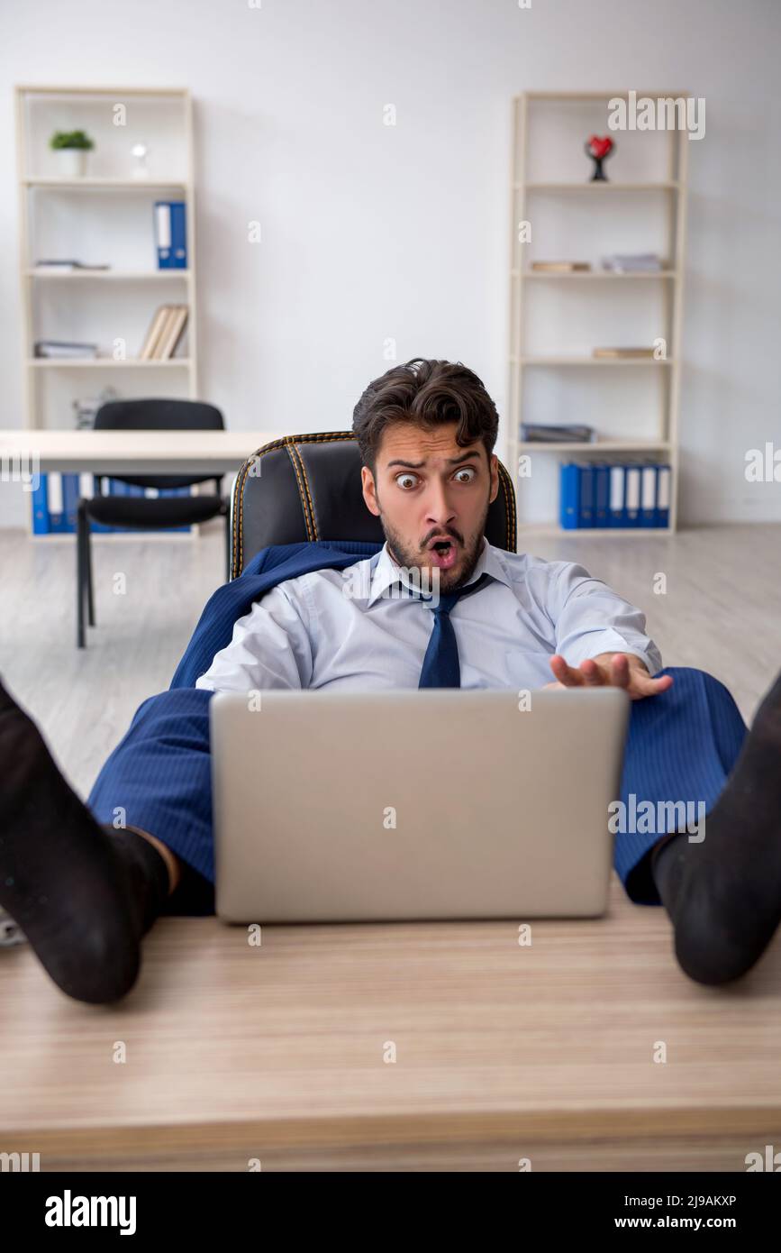 Young businessman employee extremely tired at workplace Stock Photo - Alamy