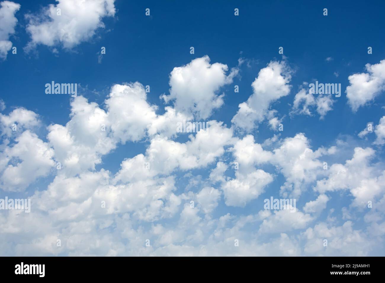 Scattering cumulus and altocumulus clouds in the summer sky on a hot ...