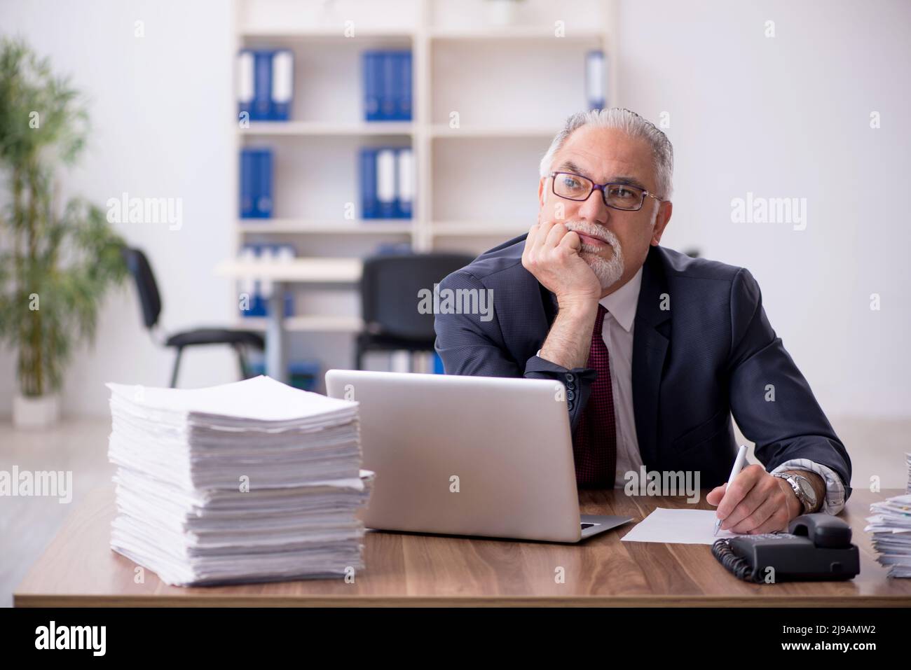 Old employee and too much work in the office Stock Photo - Alamy