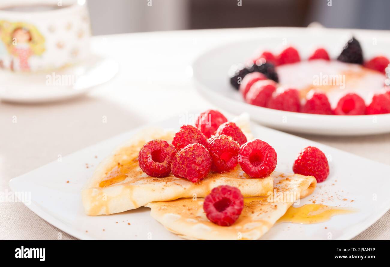 breakfast of pancakes with fresh raspberries on table Stock Photo - Alamy