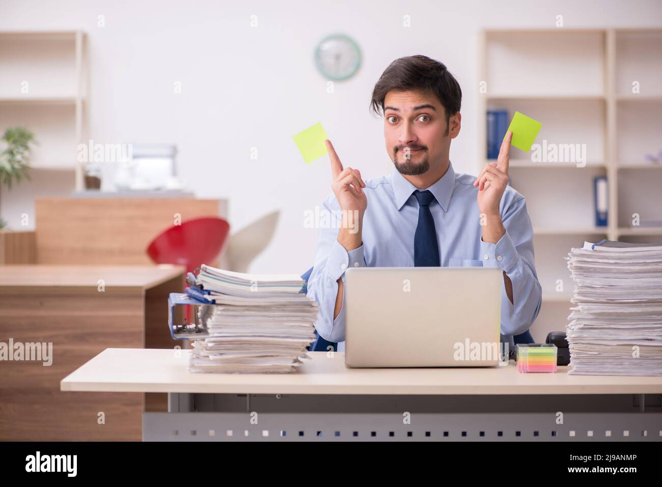 Young businessman employee and too much work in the office Stock Photo ...