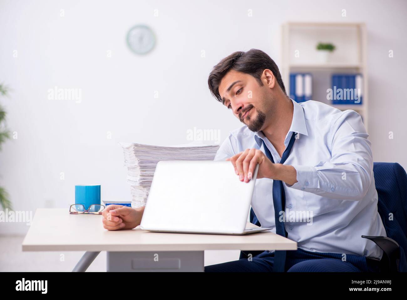 Young businessman employee working in the office Stock Photo - Alamy