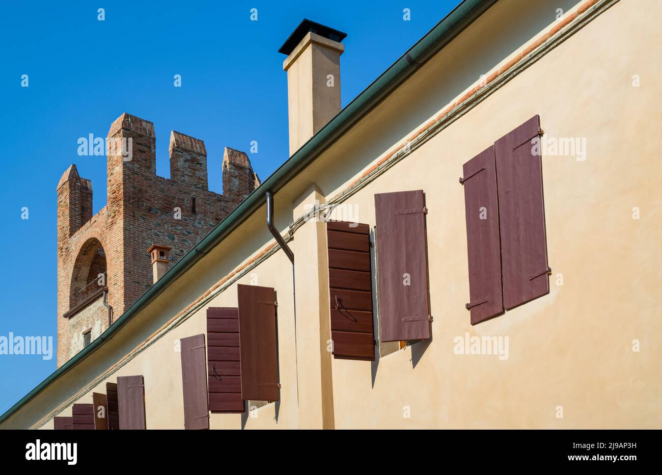 Italy, Montagnana,traditional colorful houses leaning against the ...