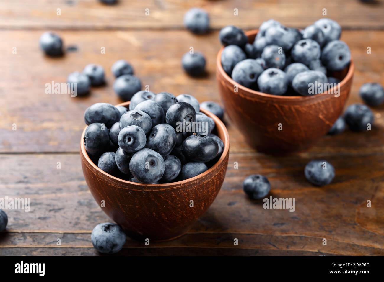 Freshly picked blueberries in a clay bowl. Healthy berry, organic food ...
