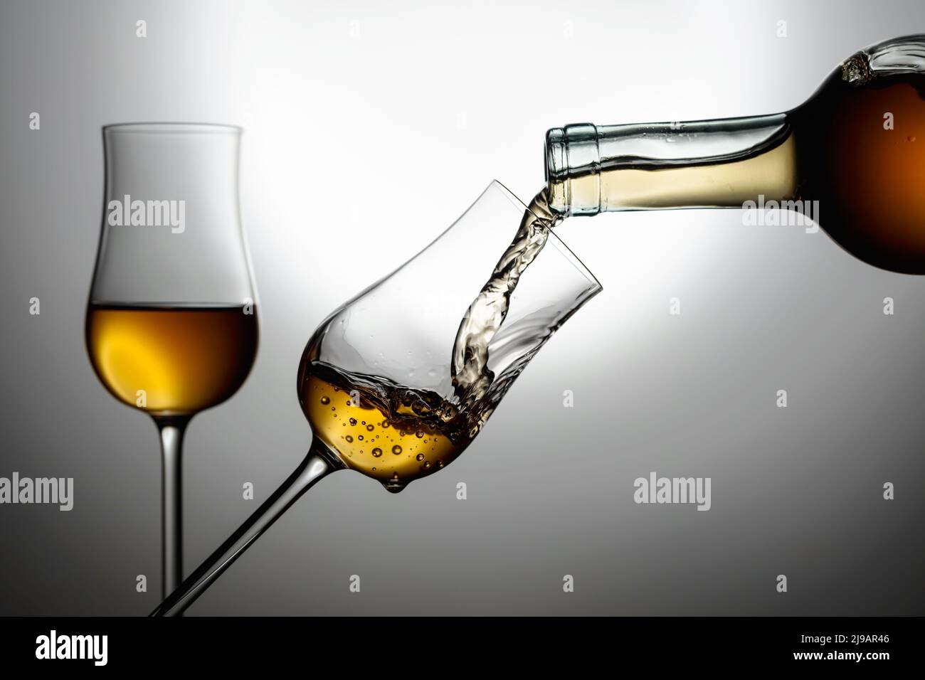 Glasses Of Premium Alcohol The Drink Is Poured From A Bottle Into A Glass Copy Space Stock