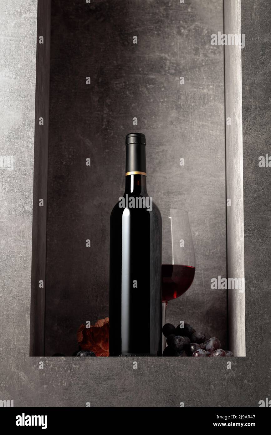 Bottle and glass of red wine with blue grapes. Copy space Stock Photo ...