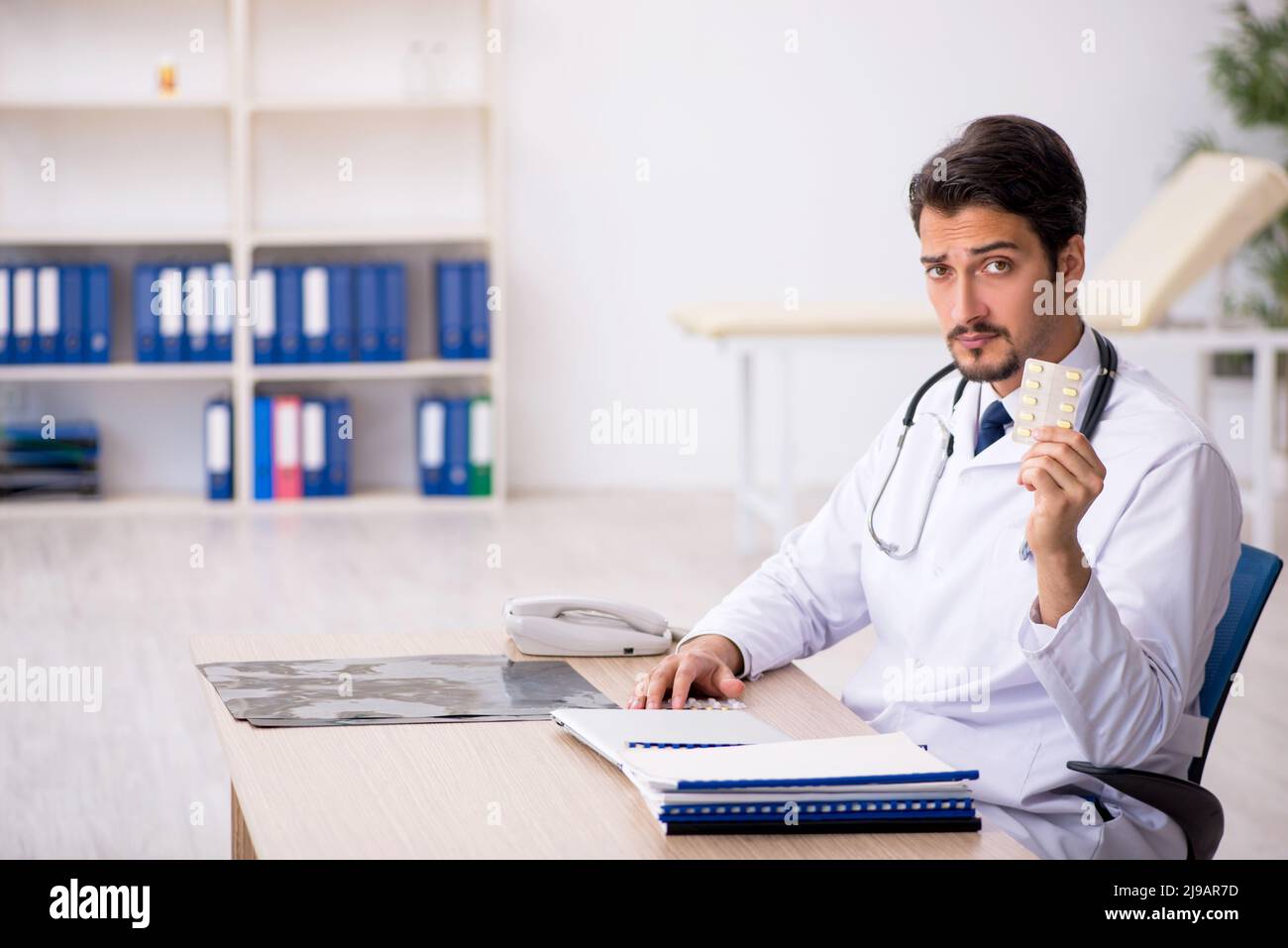 Young doctor working in the clinic Stock Photo - Alamy