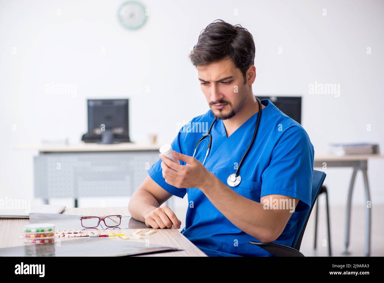 Young male doctor working at the hospital Stock Photo - Alamy