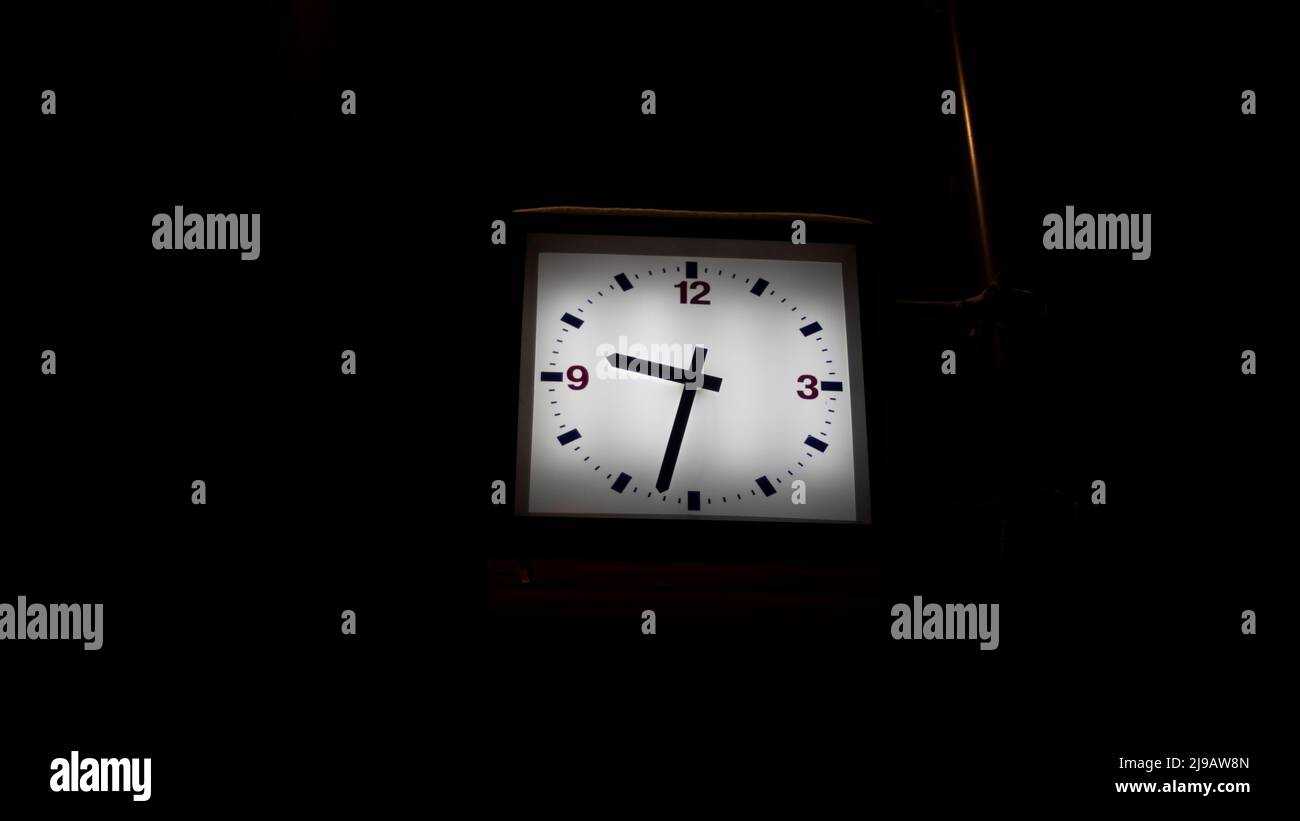 Clock scoreboard. Clock at night. Dial in city. Street time. Details of ...