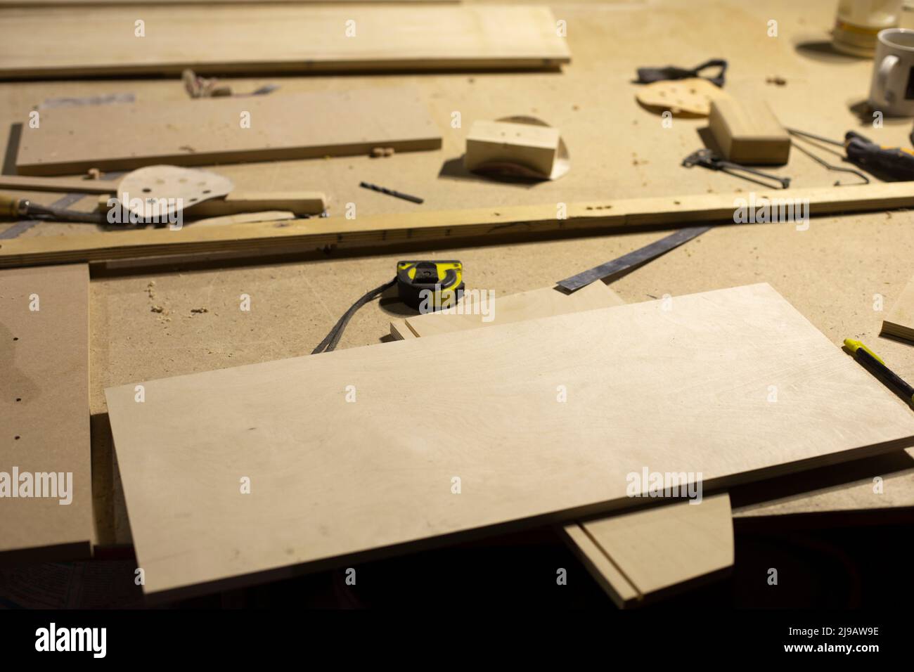 Details of carpentry workshop. Wooden objects on table. Table in ...