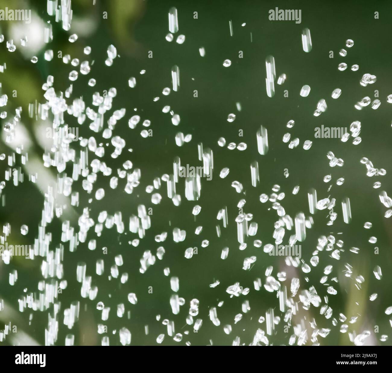water droplets captured in mid-air from a garden solar powered water ...