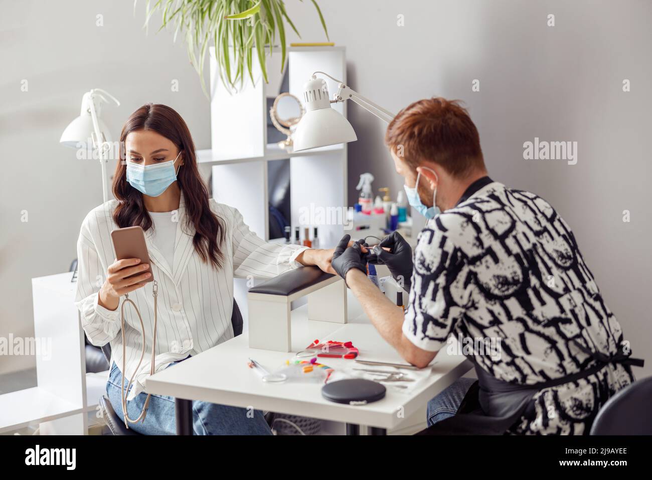 Female client getting treatment manicure procedure in salon Stock Photo ...