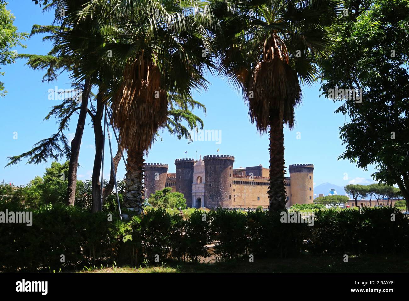 The walls of a medieval castle viewed from a public garden in Naples ...