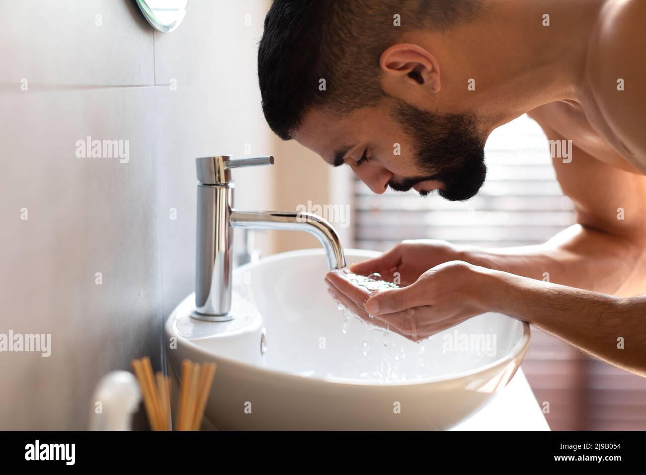 Man washing face bathroom hi-res stock photography and images - Alamy