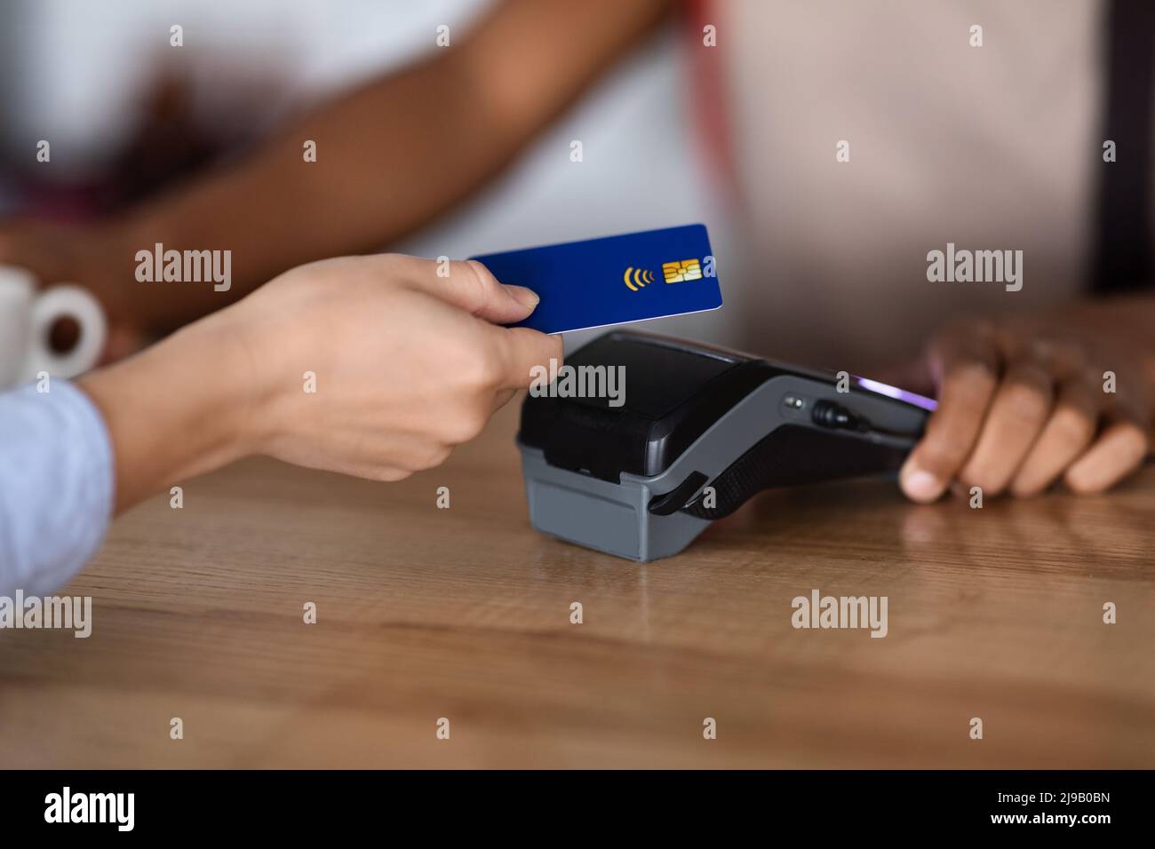 Young woman pays card bar hi-res stock photography and images - Alamy