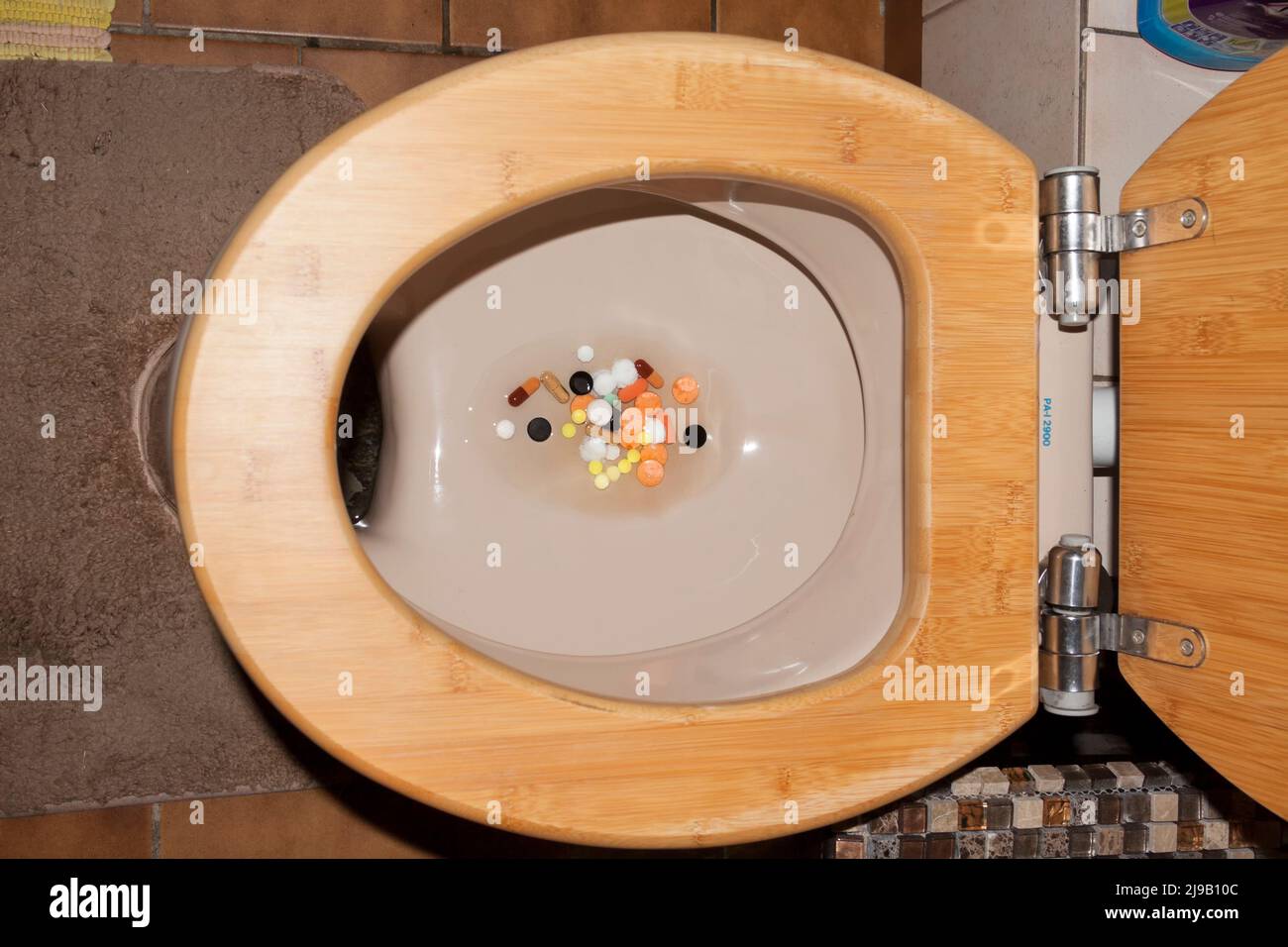 Wrong disposal of pills in the toilet Stock Photo - Alamy