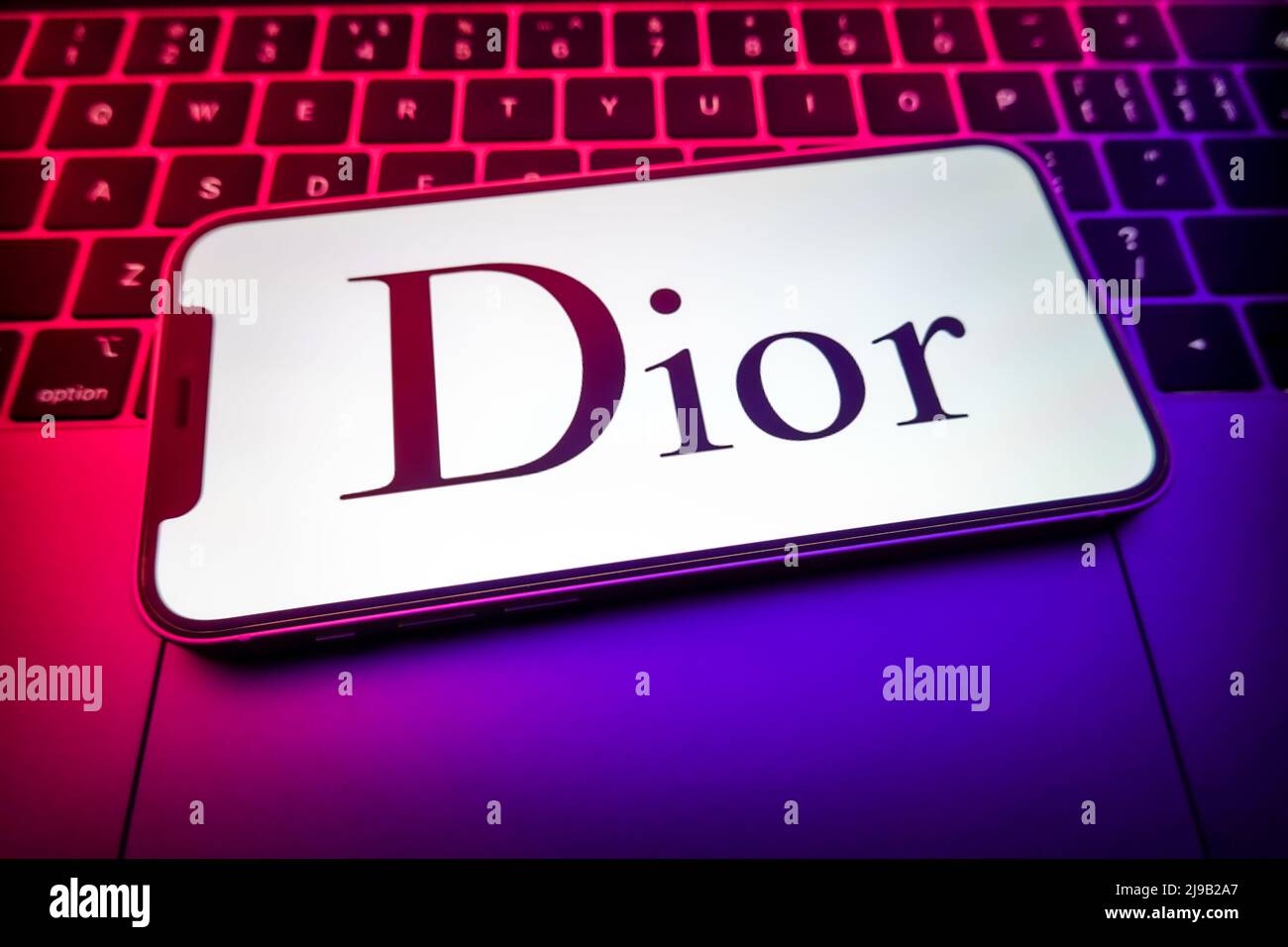 In this photo illustration, a Dior logo is displayed on the screen of a ...
