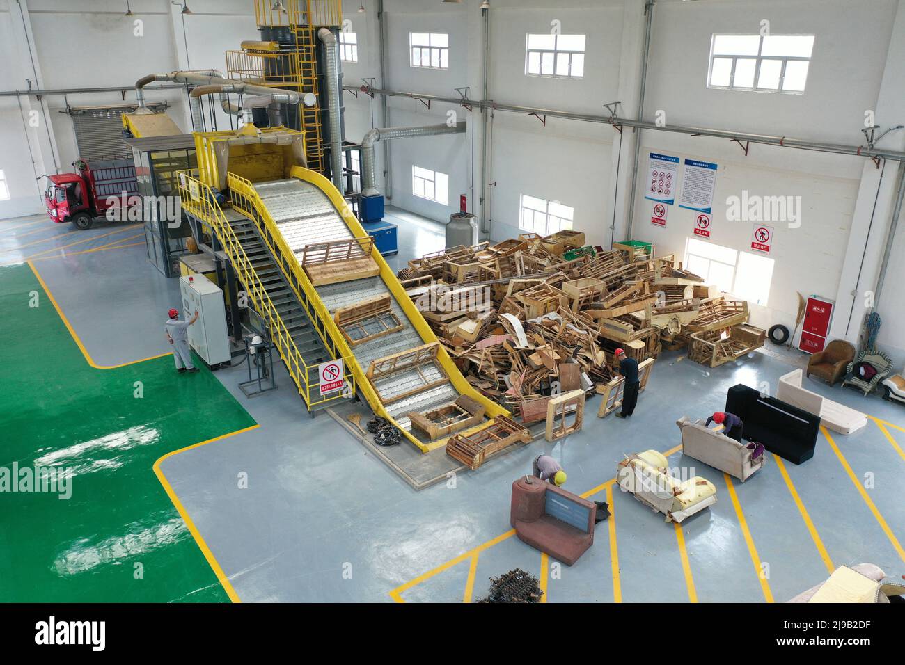 MEISHAN, CHINA - MAY 22, 2022 - Workers transport large pieces of waste ...