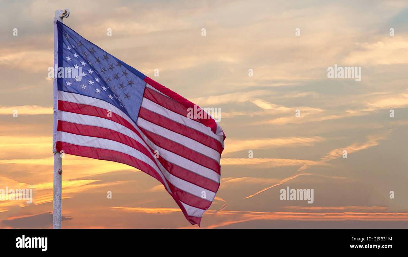 illustration of American Flag waving in sky backdrop Stock Photo - Alamy