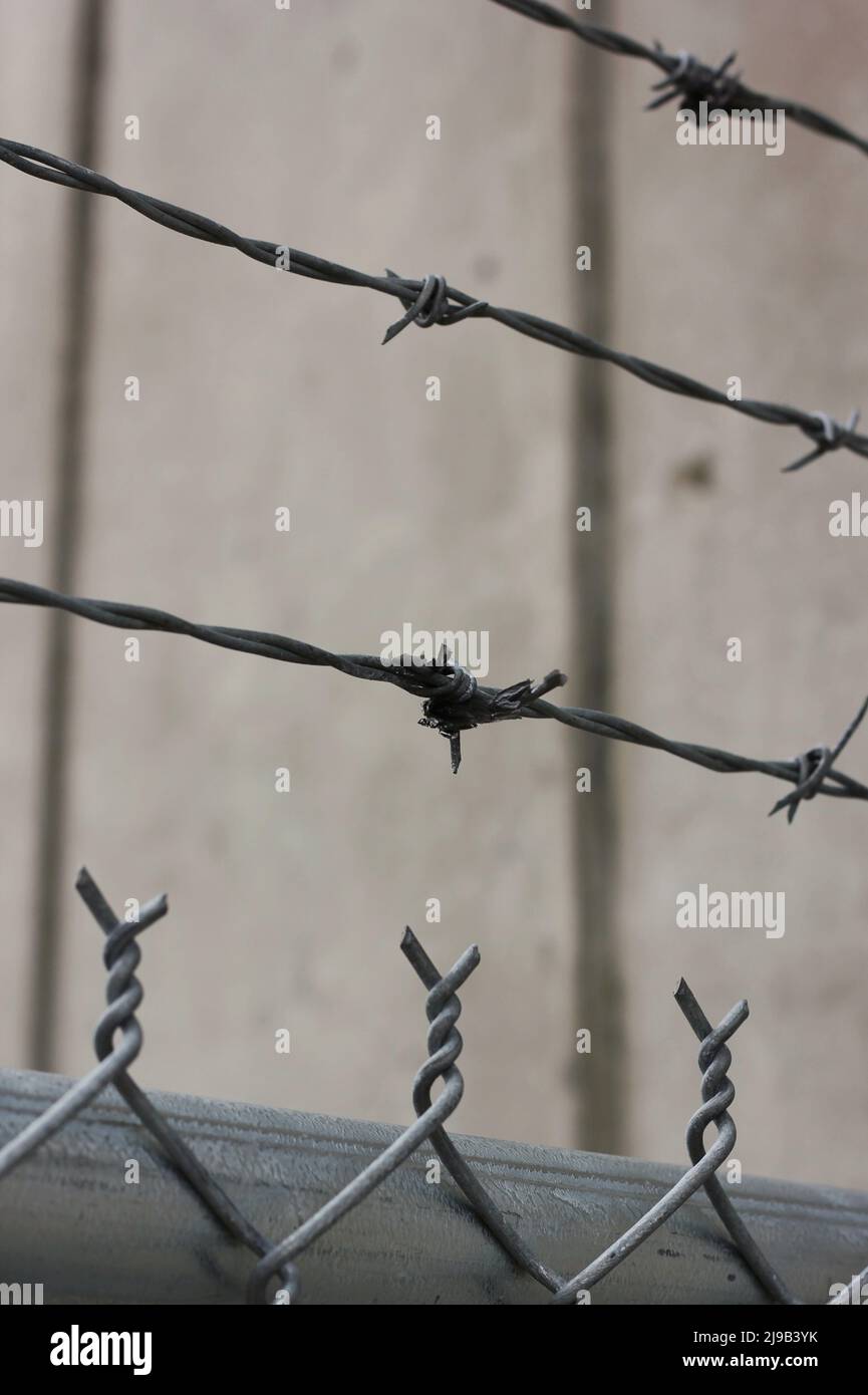 Barbed wire fence protecting something important Stock Photo - Alamy