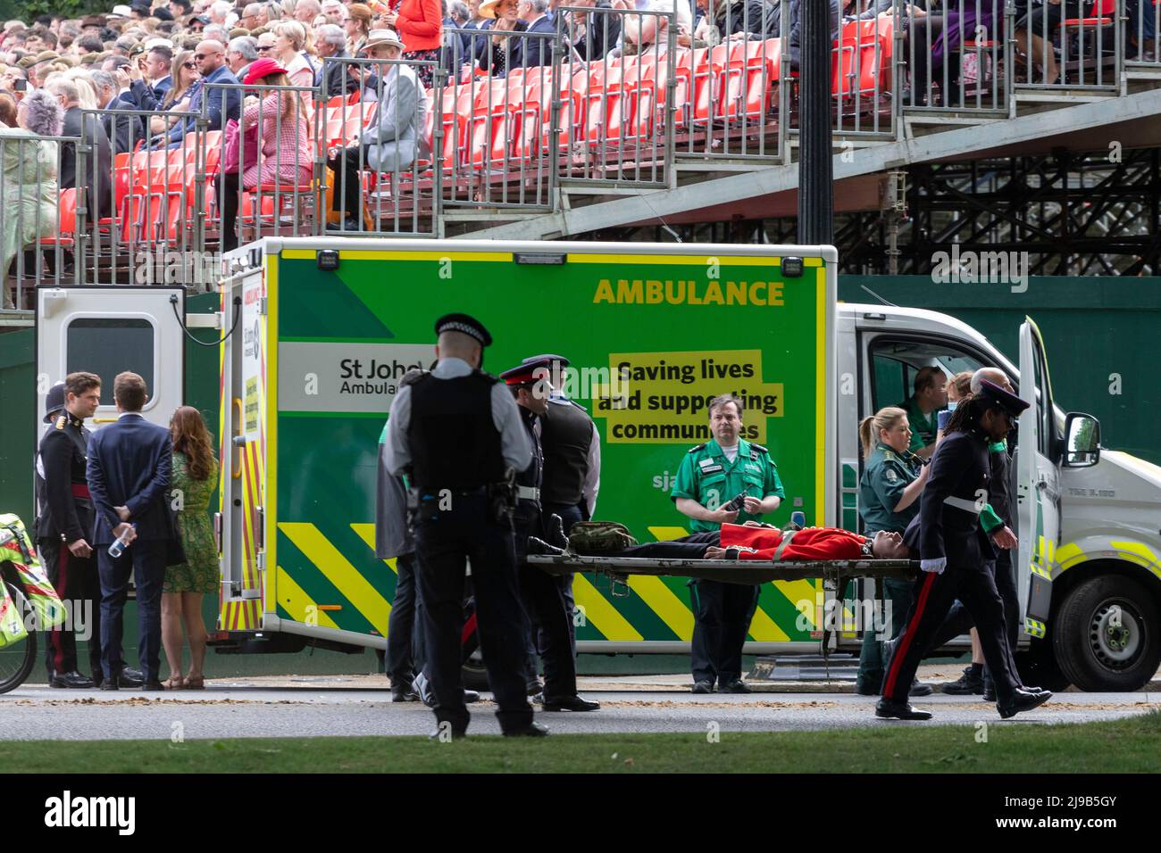 A member of the Irish Guards fainting under the high temperature today ...
