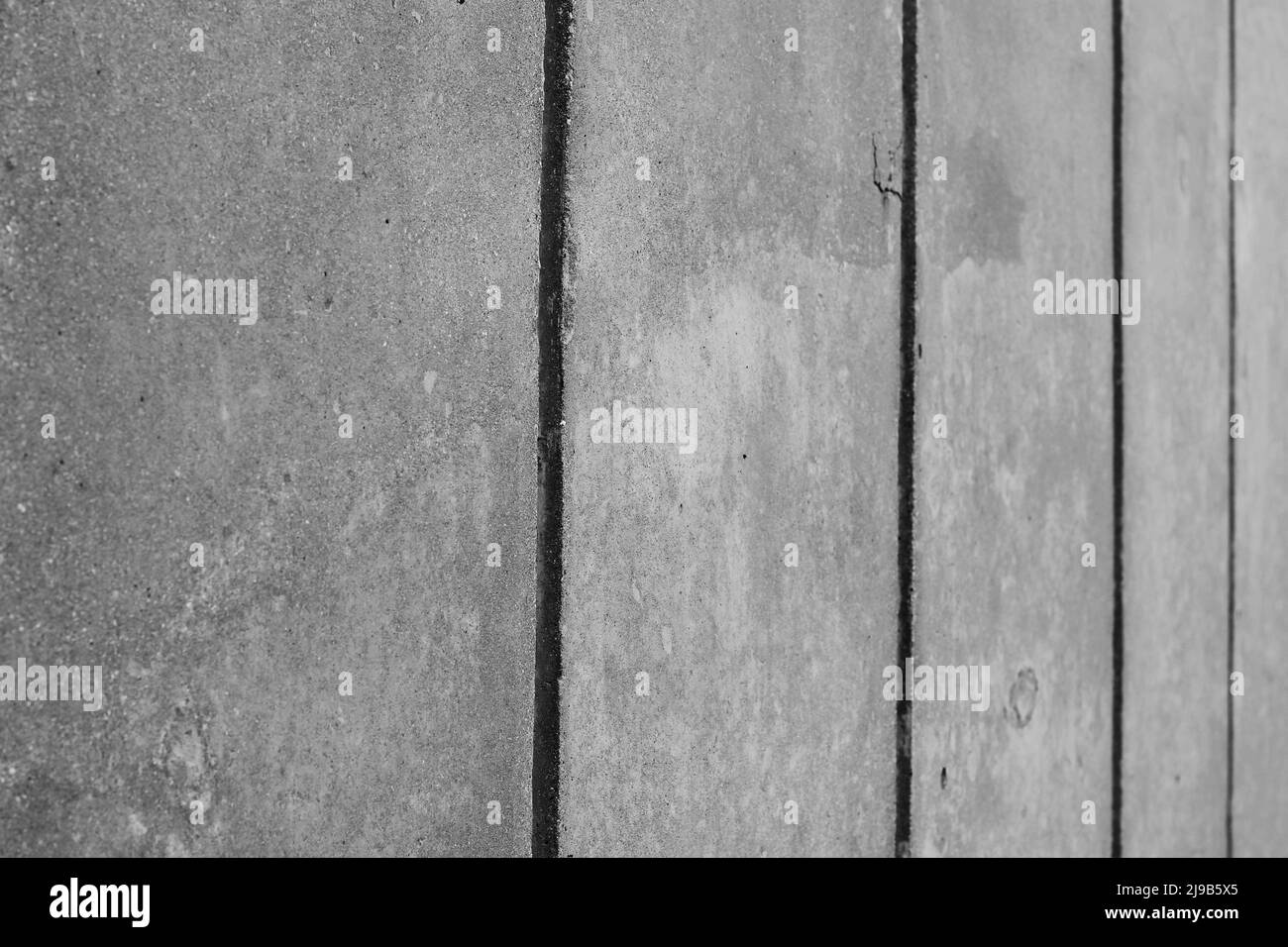 A minimalist view of a concrete panel floor with a radial pattern in ...