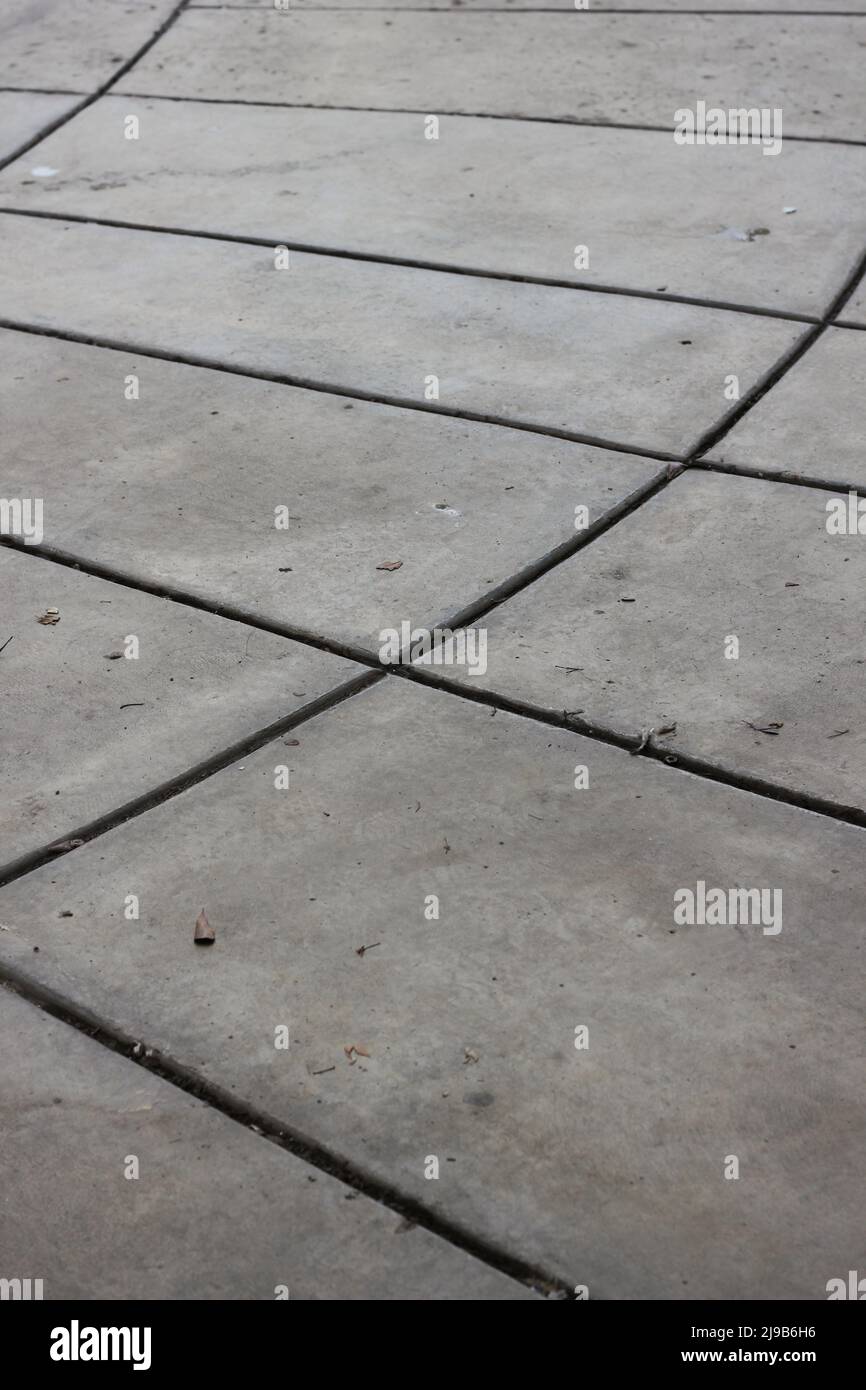 A minimalist view of a concrete panel floor with a radial pattern in ...