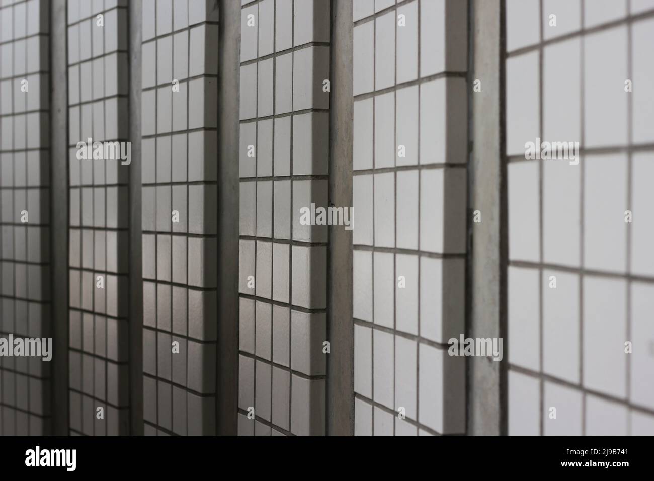 Square tiles on a wall in a grid repeat pattern Stock Photo - Alamy