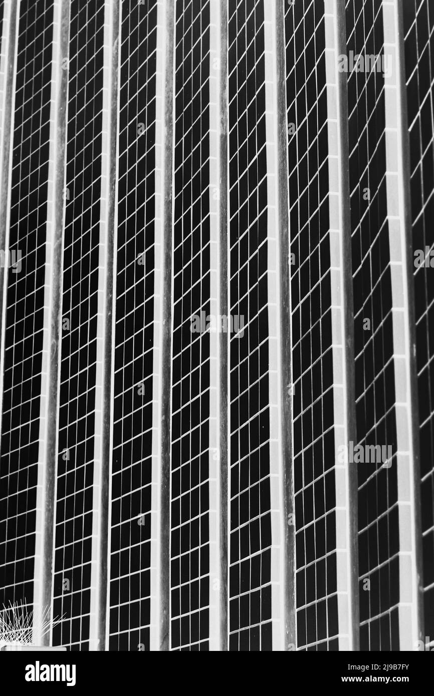 Square tiles on a wall in a grid repeat pattern in black and white film ...