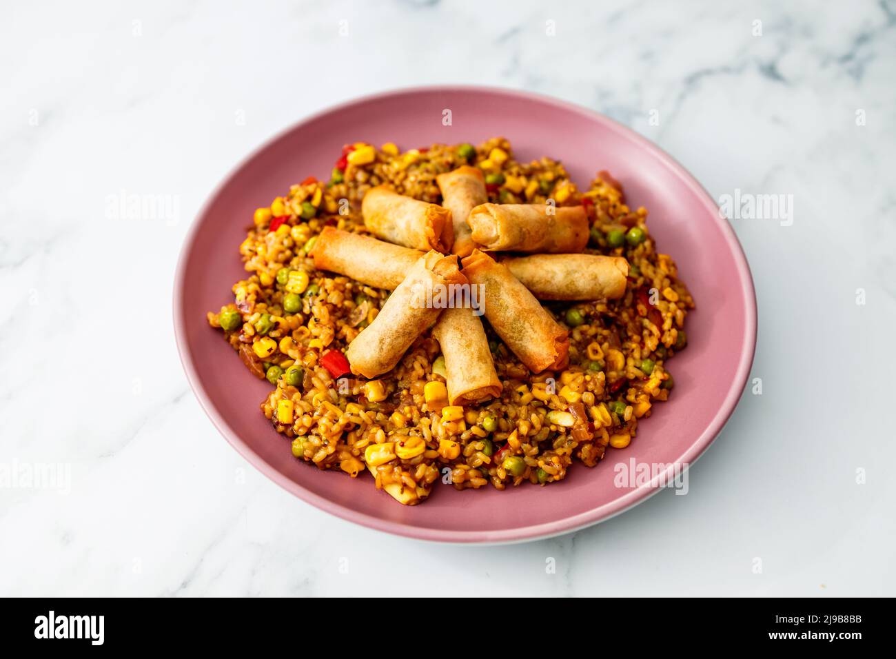 vegan fried rice with vegetable spring rolls, healthy plant-based food ...