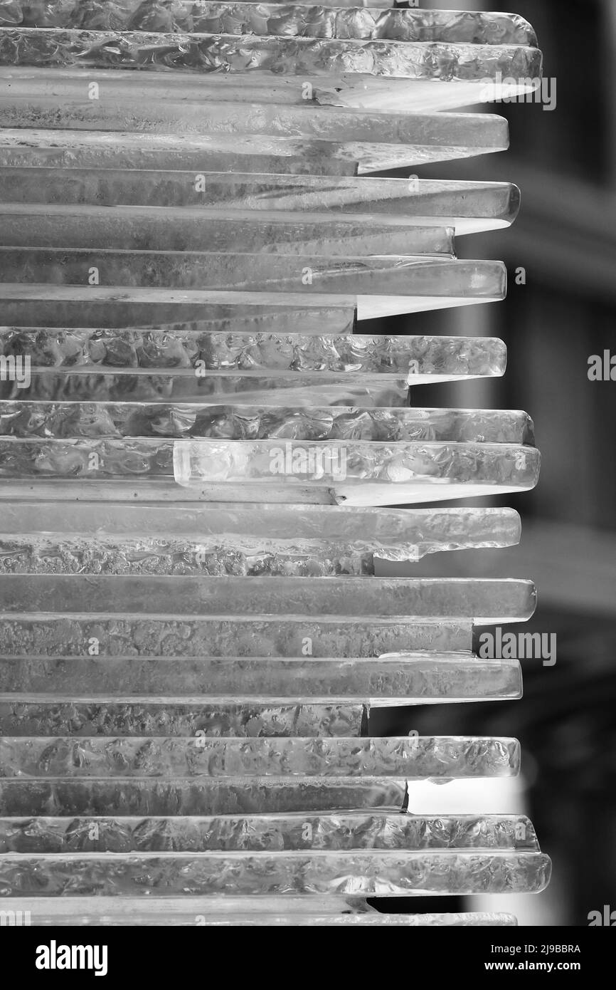 Layers of glass set upon one another as a stack of horizontal plates in ...