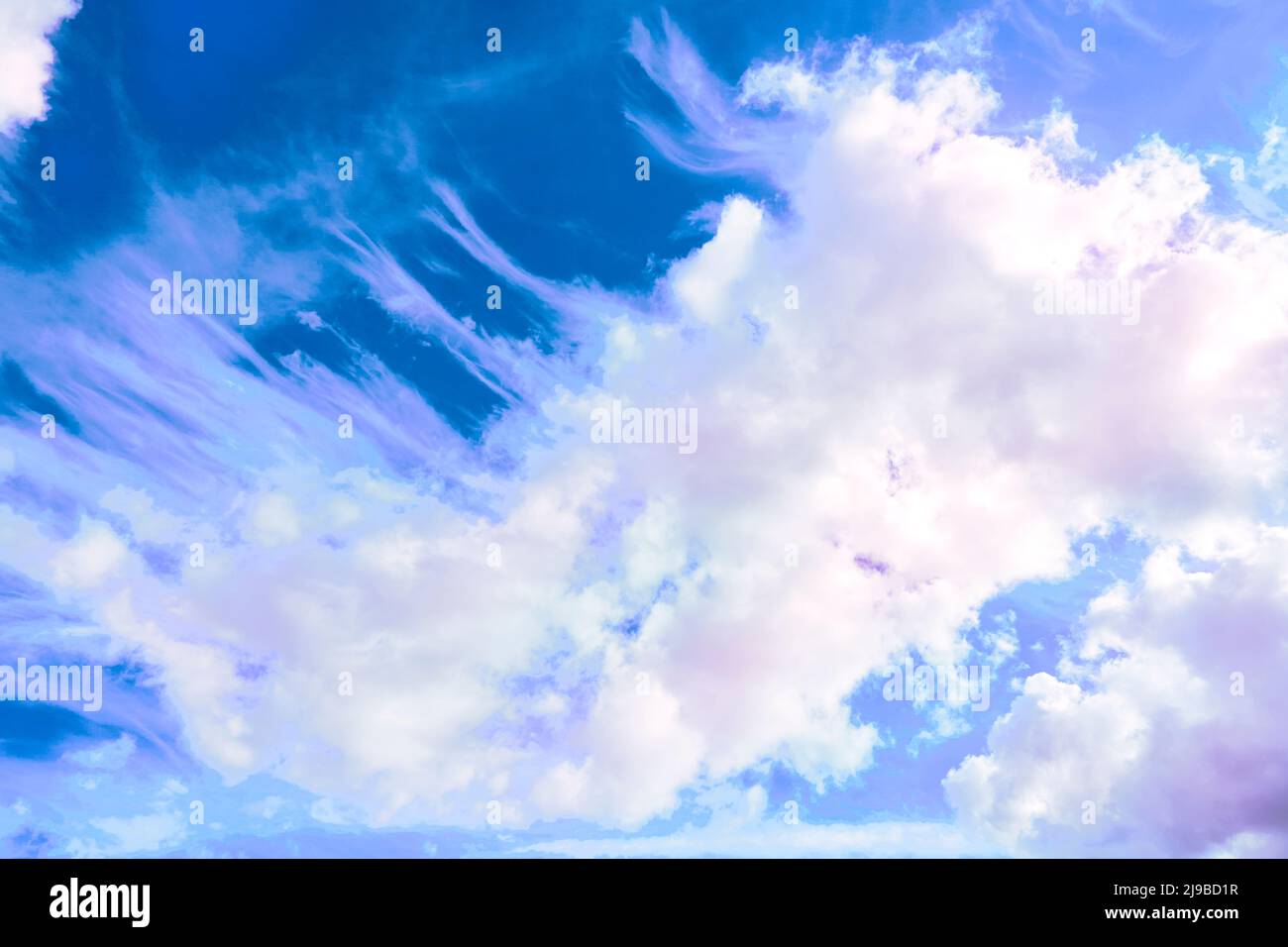 Saturated blue sky with flying pink clouds Stock Photo - Alamy