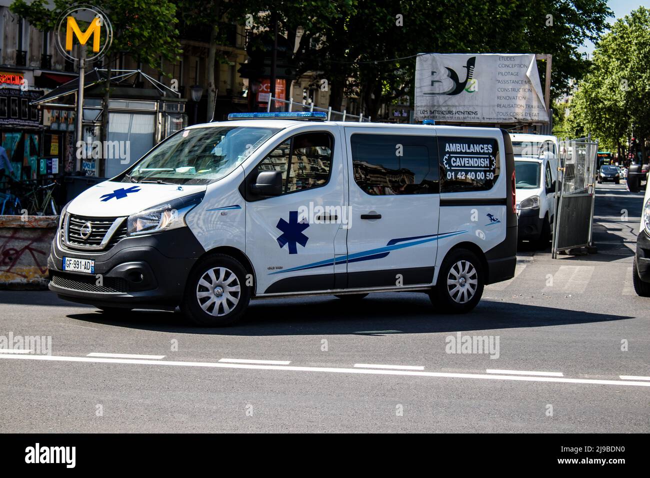 Paris, France - May 21, 2022 Ambulance driving through the streets of ...