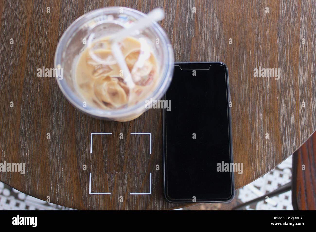 phone screen mockup and a glass of cold coffee that is ready to drink ...