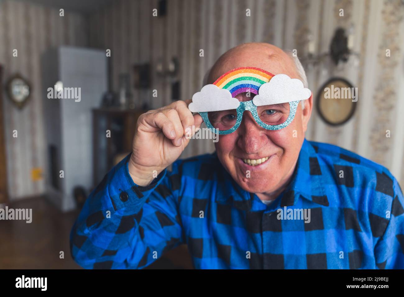 medium closeup portrait of a joyful senior Caucasian man with rainbow ...