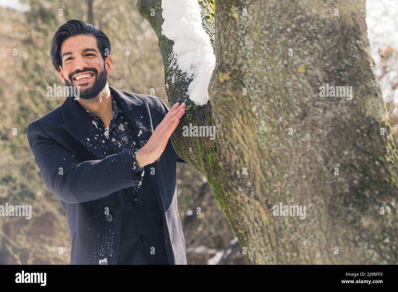 Man standing behind tree in hi-res stock photography and images - Alamy