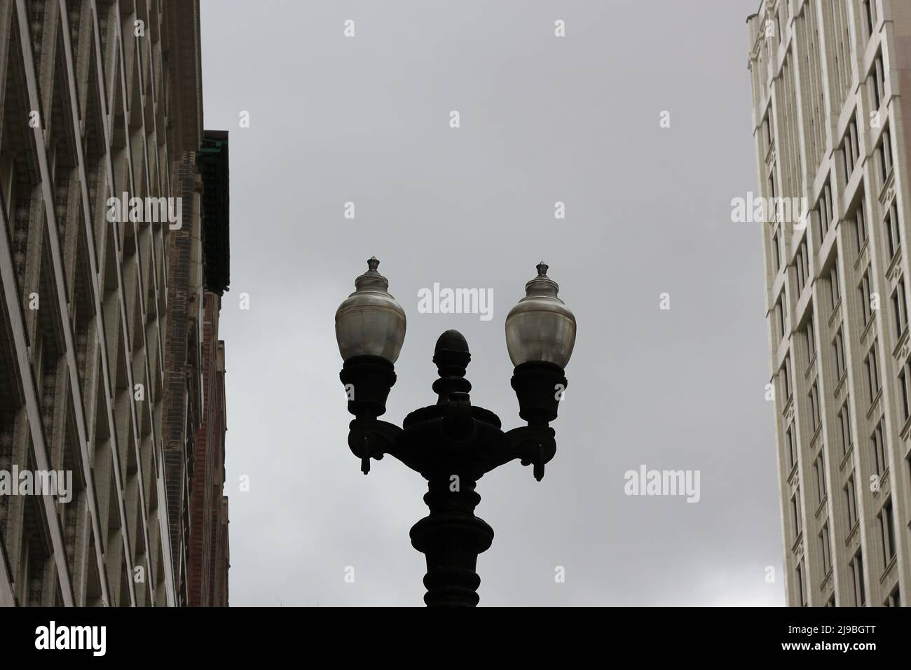 Urban street lamp standing between two skyscrapers in the downtown area ...