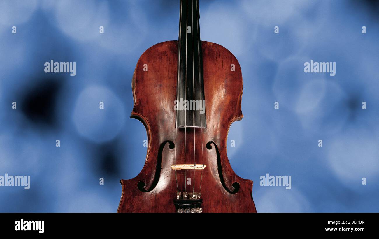 Detail of a Body of violin on blue blurred background Stock Photo - Alamy